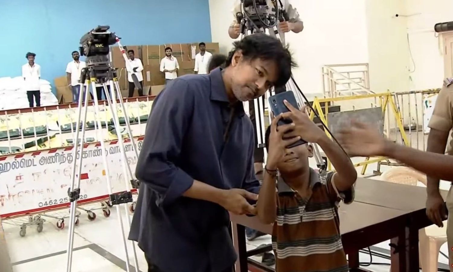 Vijay gets on to field, gives aid to flood-hit in Nellai