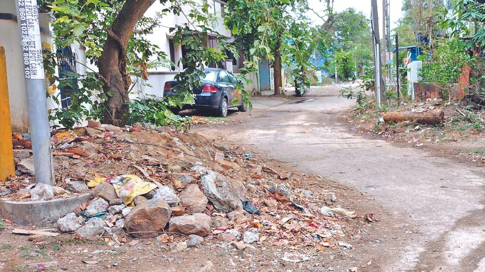 Untarred road, scattered debris welcome you at Santhoshapuram
