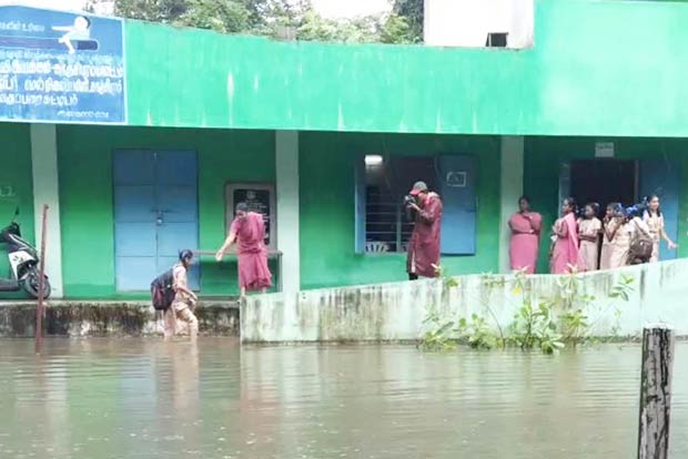 Students wade through flooded campus to classes